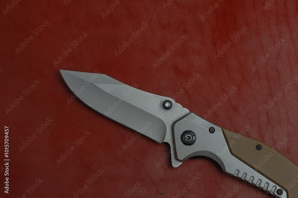 An unfolded tactical military knife with a sharp blade. Tool against ...