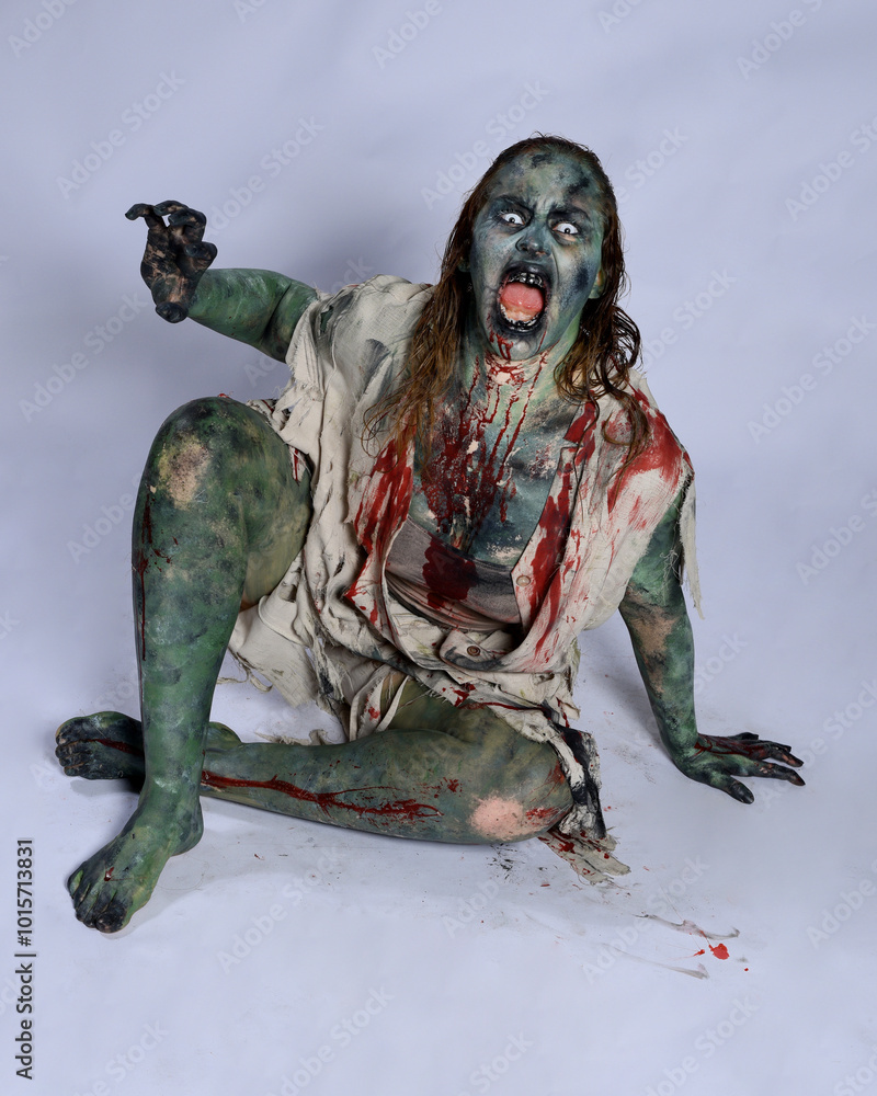 portrait of scary female model wearing spooky halloween costume, ripped ...