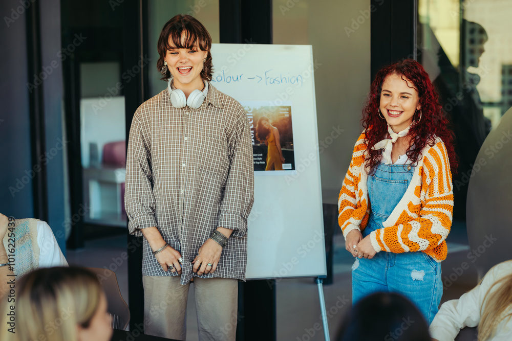 Confident students giving a creative presentation in a classroom ...