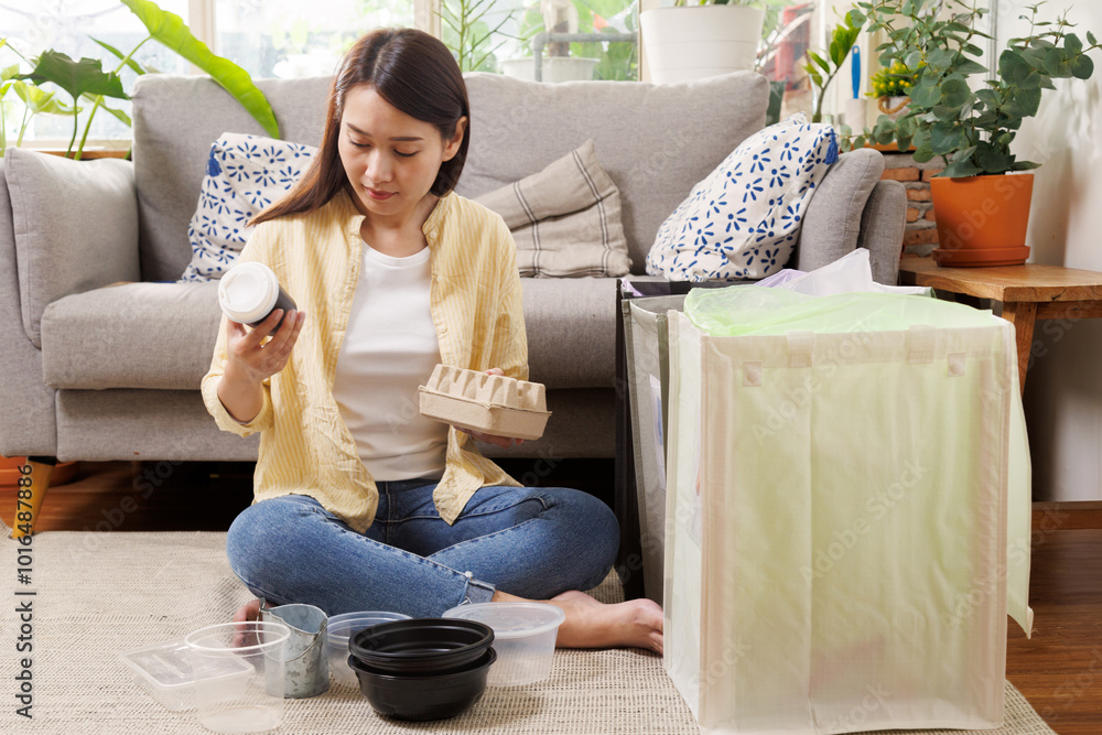 Asian female separate garbage at home. young woman sorting and ...