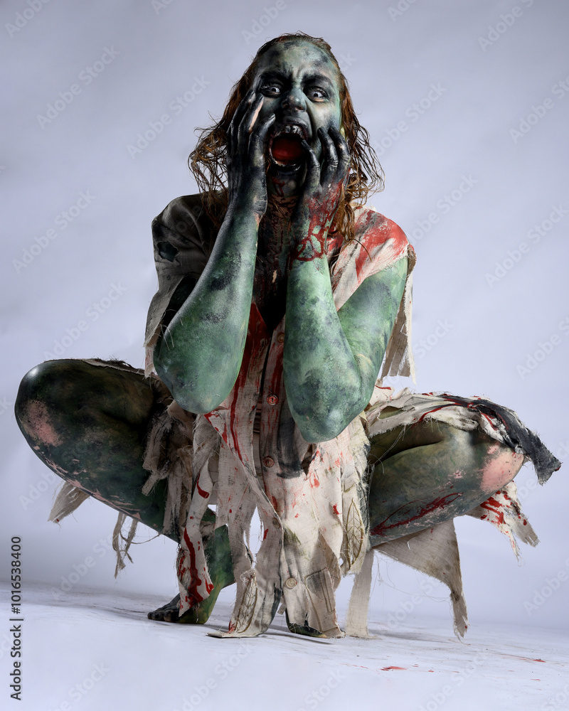 portrait of scary female model wearing spooky halloween costume, ripped ...