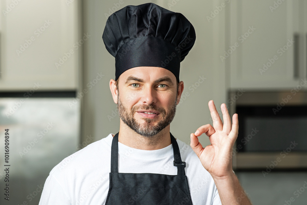 Handsome man chef in uniform cooking in the kitchen. Restaurant menu ...