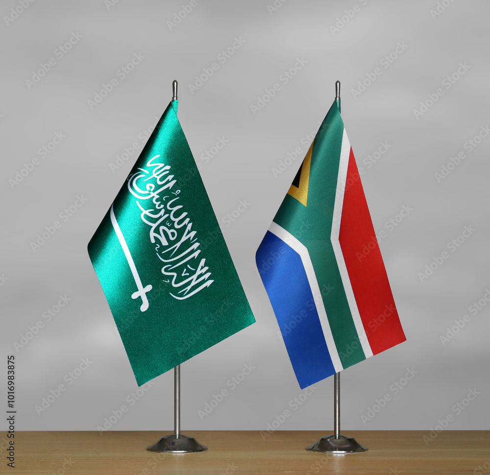 Table flags of South Africa and Saudi Arabia on grey blurred background ...
