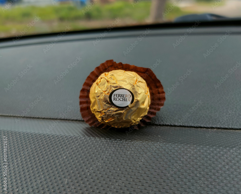 Ferrero Rocher chocolate on a dashboard car Stock Photo | Adobe Stock