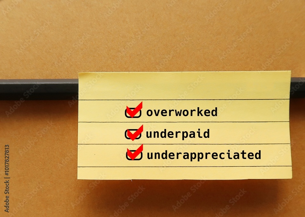 Office envelope with text note written OVERWORKED UNDERPAID and ...