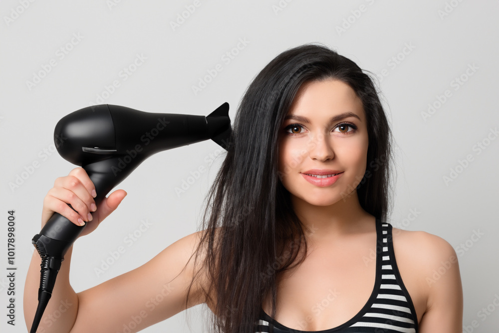 Girl with white hair is drying her hair with dryer. female beauty care ...