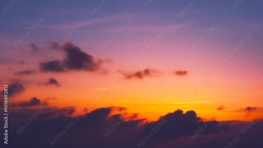 Vibrant hues of orange and purple fill the sky, transforming ...