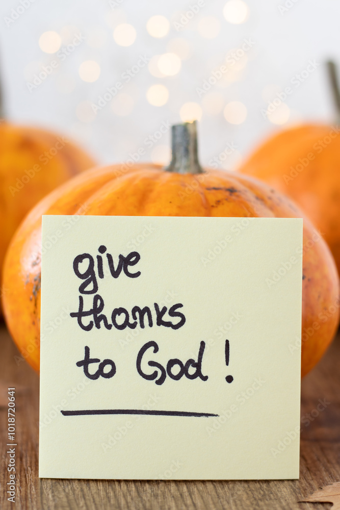 Give thanks to God, handwritten note in front of pumpkin with white ...