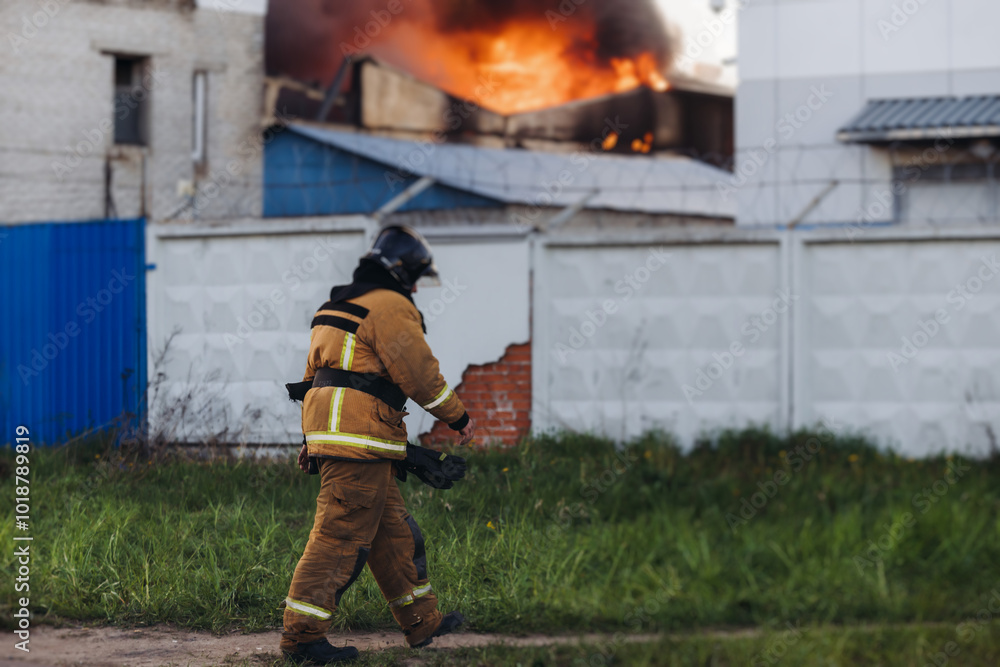Group of fire men in uniform during fire fighting operation in the city ...