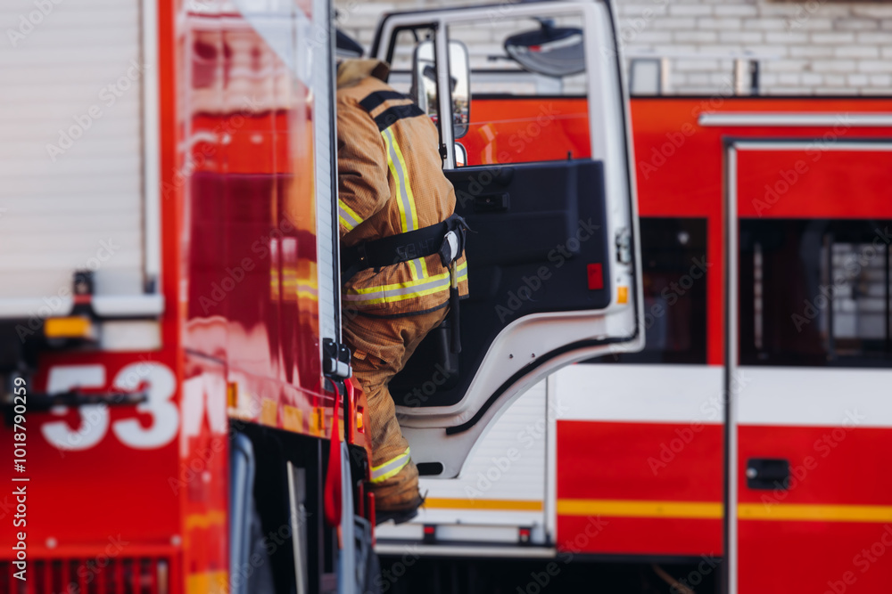 Group of fire men in uniform during fire fighting operation in the city streets, firefighters ...