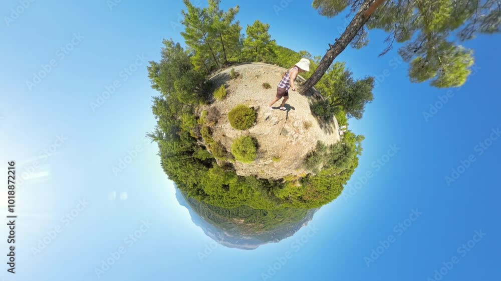 A Tiny Planet effect transforms a woman on a small hill into a ...