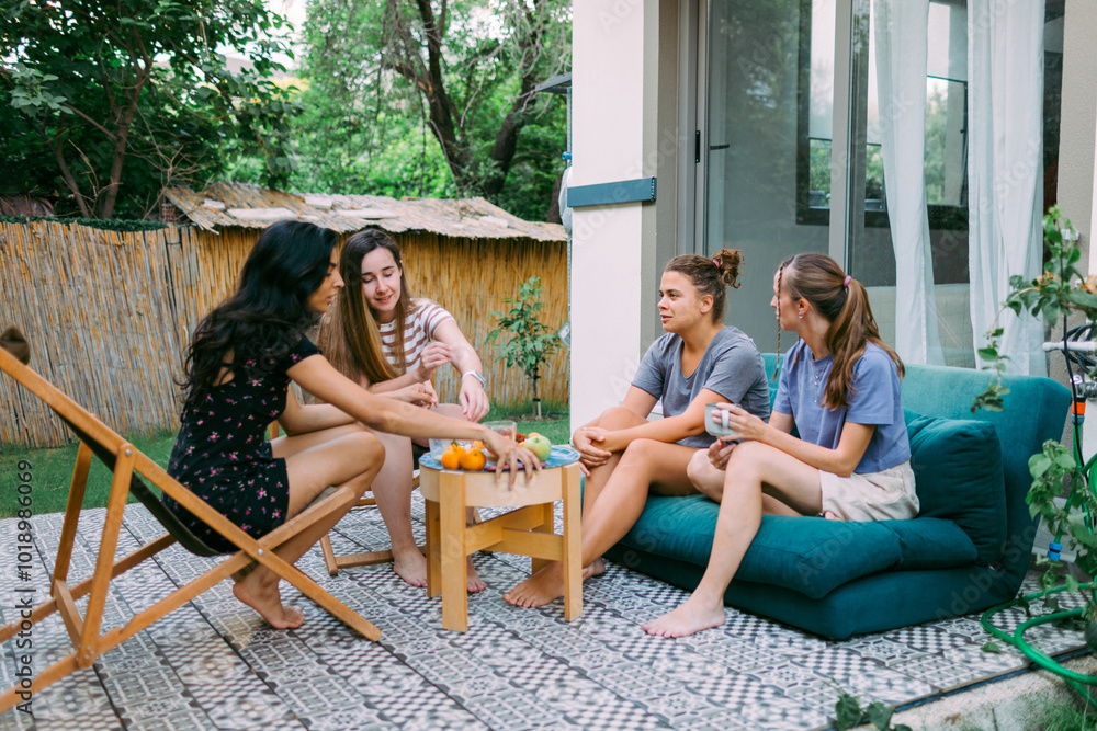 Best friends having dinner party at the backyard, talking all together ...