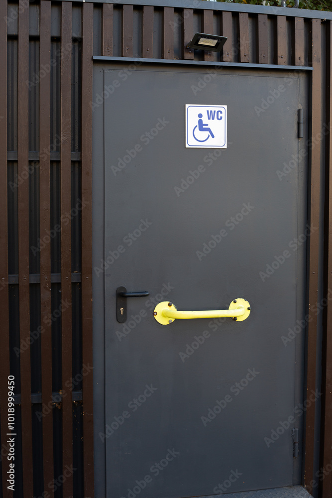 Entrance door to public toilet for disabled people, vertical photo of ...