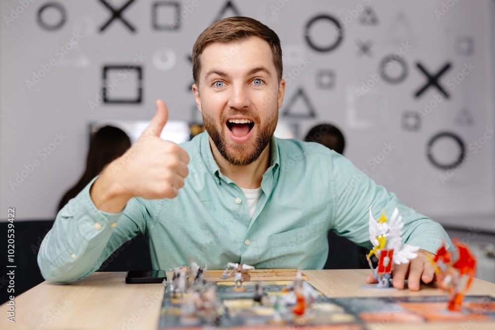 Man with board game piece while practicing strategy in home alone. A ...