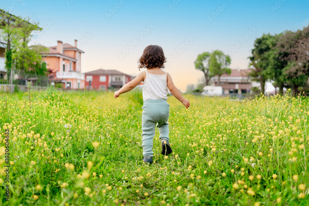 Little child running free in flower meadows in the countryside.Concept ...