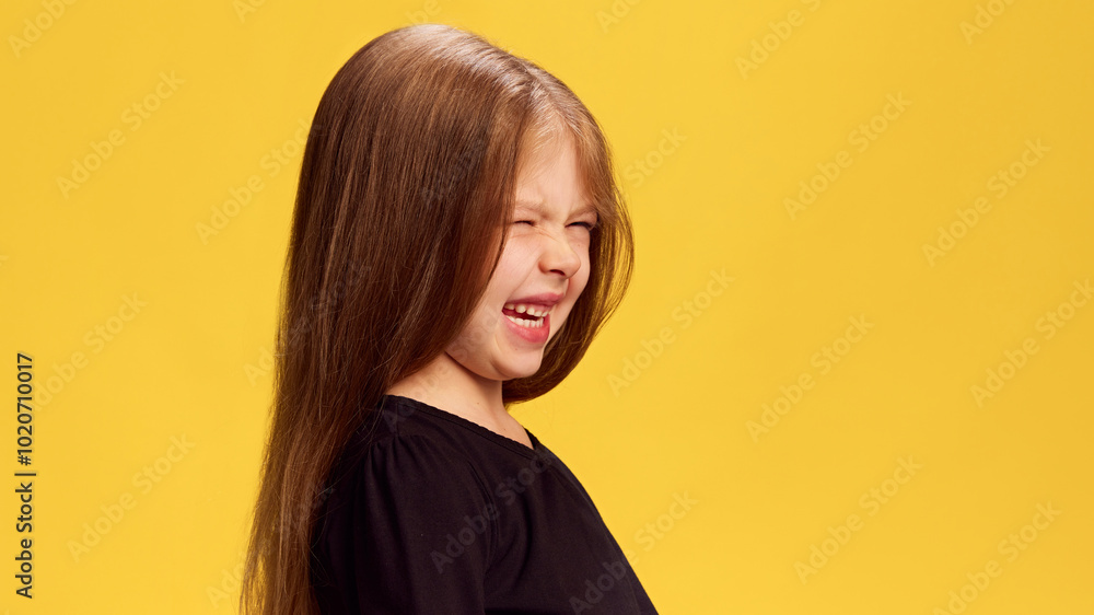 Side view portrait of girl with sleek, long hair gives playful laugh ...
