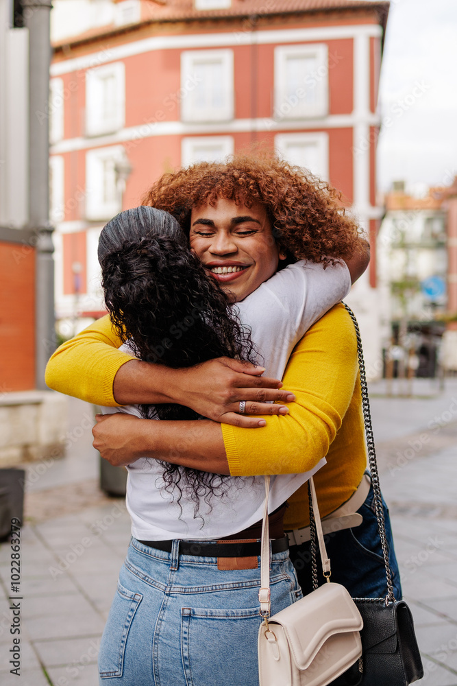 Transgender woman hugging friend in city street. Friends meeting, gen z ...