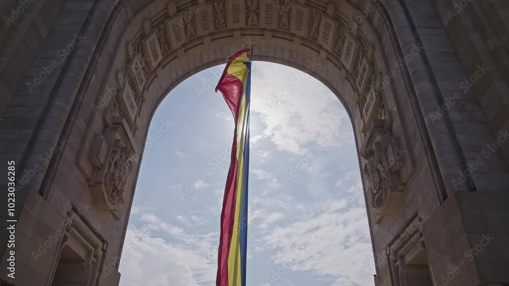 The Romanian flag waving in the wind at the triumphal arch. The Red ...