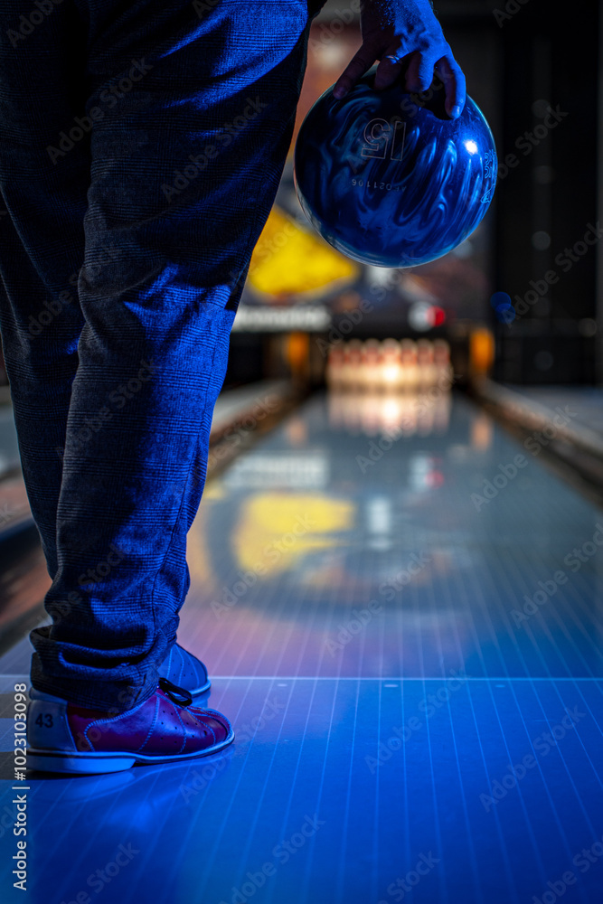 This photo shows a bowler getting ready to throw a strike. The blue ...