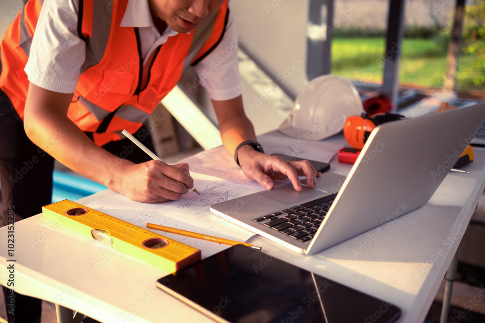 Architecture engineer designing blueprint using computer tablet ...