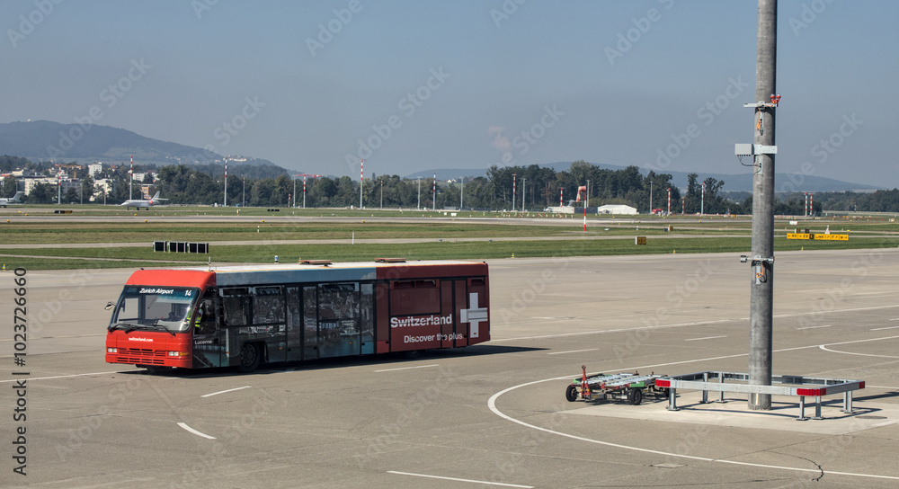 Airport shuttle bus with Swiss Airlines logo on the runway arriving at ...