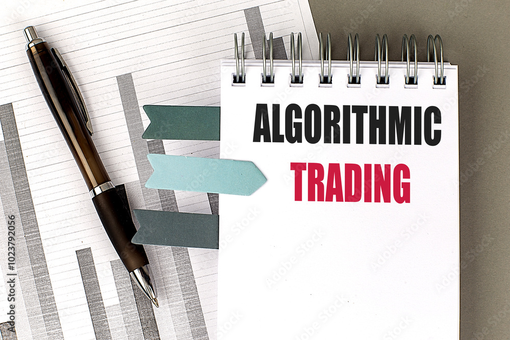 Algorithmic trading text on notepad with pen, financial charts, and ...