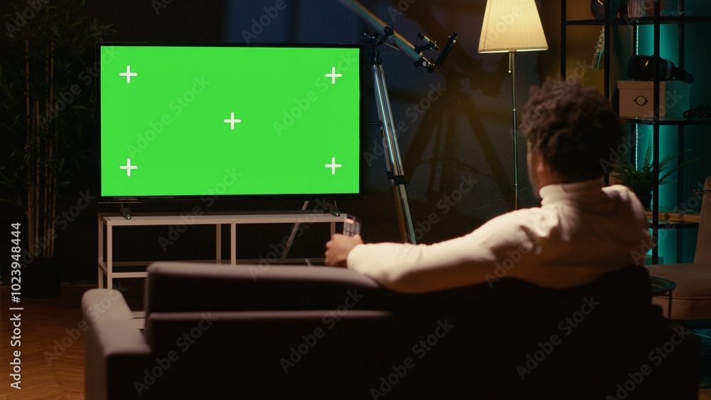 African american man zapping through isolated screen TV channels using ...