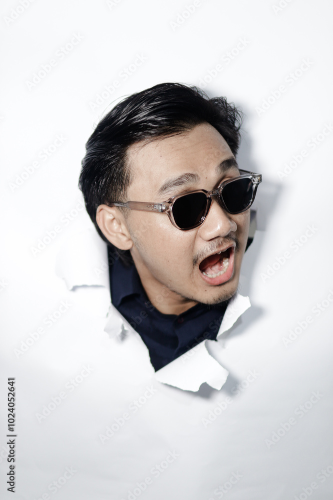 Horizontal shot of happy redhead young asian man wears spectacles looks ...