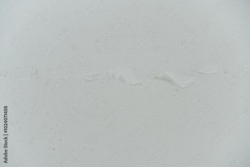 White car body with a small thin scratch or streak of a different color ...