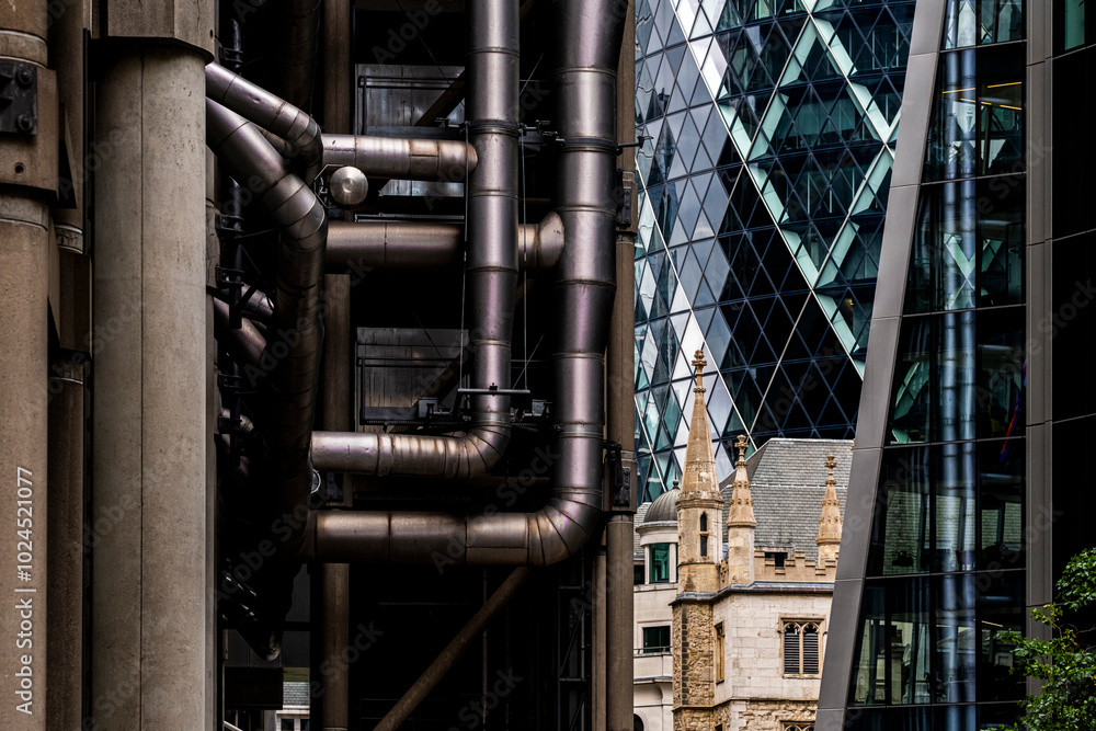 Foto de Cityscape featuring a juxtaposition of industrial pipes, modern ...