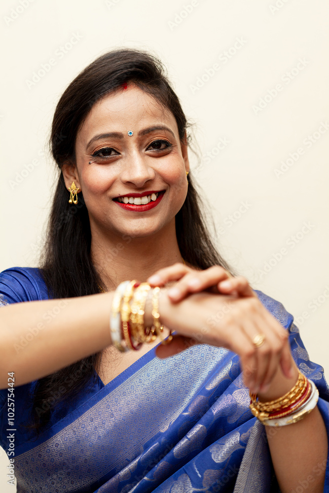 A joyful Bengali Indian woman from India, dressed in a traditional ...