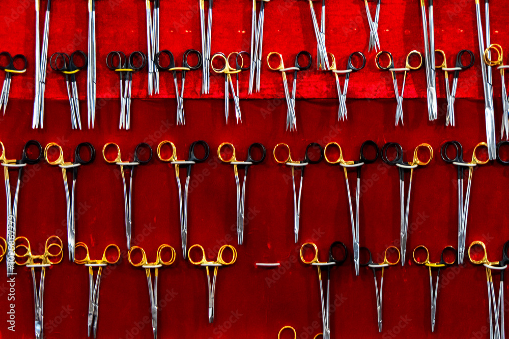 Surgical instruments, medical scissors and various types of clamps hang ...