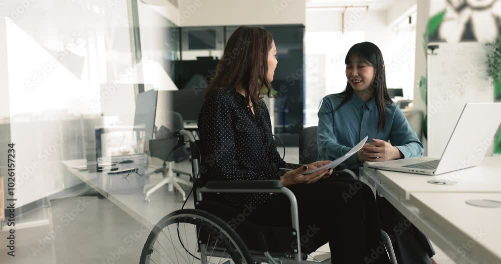 Office employee with disability sits in wheelchair lead talk with ...