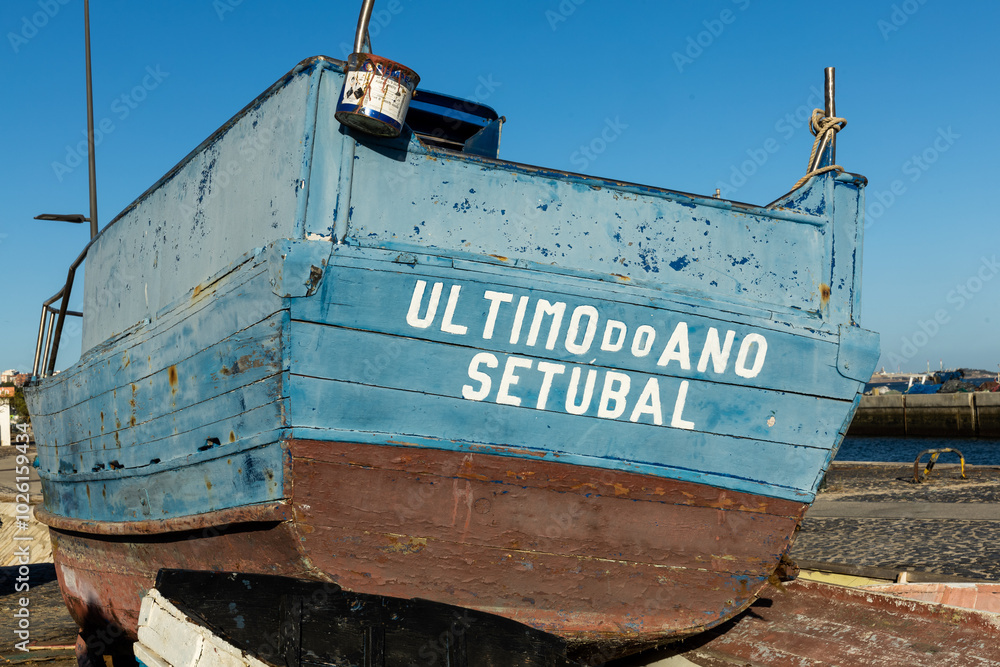 Small traditional fishing boat on the quay for repairs and painting ...