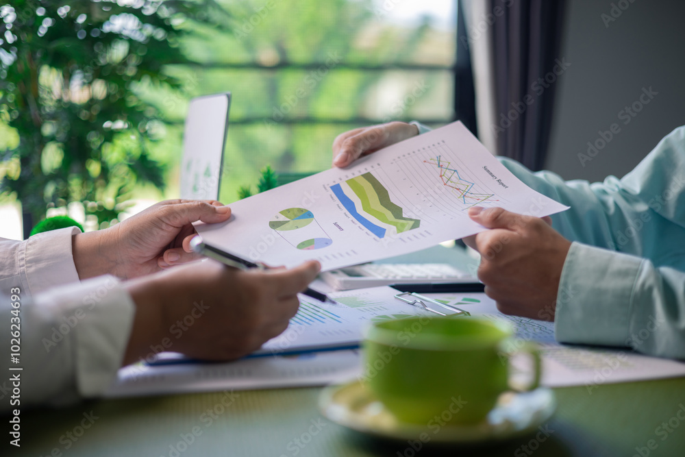 Reviewing sustainability reports and environmental performance charts ... Reviewing sustainability reports and environmental performance charts ...