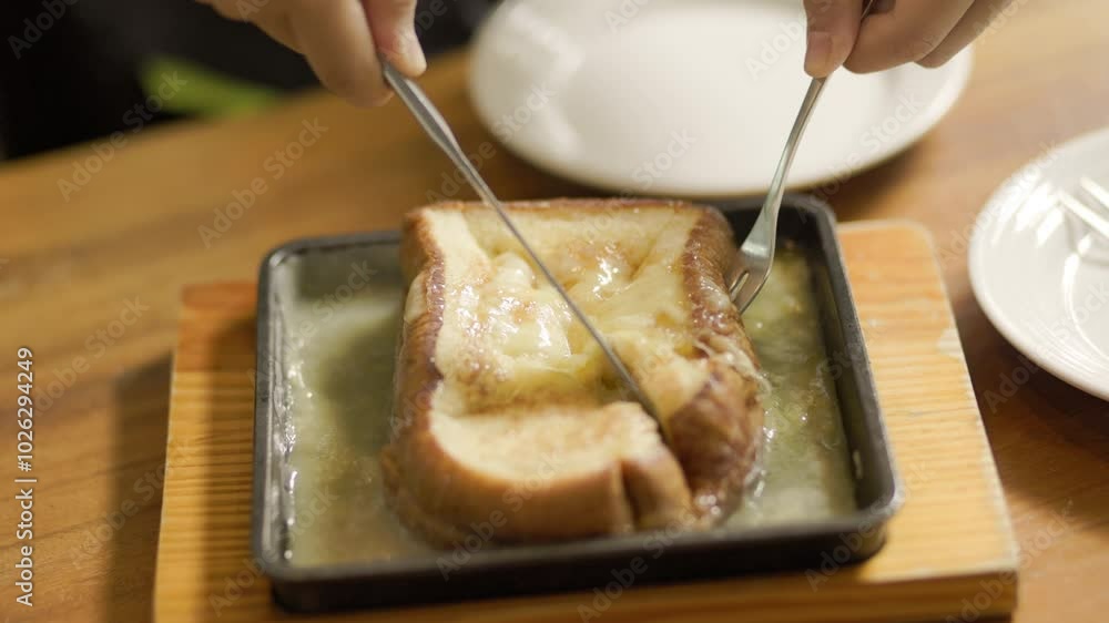 Cheese toast served on a hot plate with a wooden board, colourful and ...