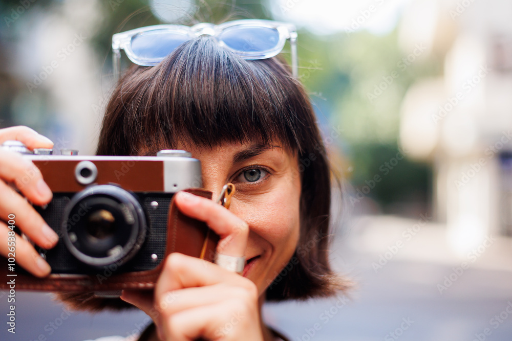 girl taking pictures. Girl walking around the city taking pictures with ...