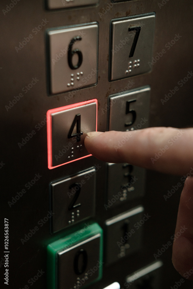 buttons in a new elevator with braille, a man presses button four Stock ...