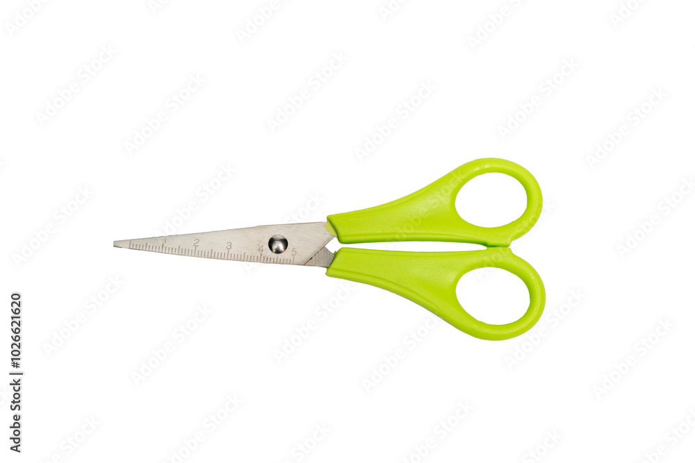 A pair of green scissors with a ruler on the handle on a transparent ...