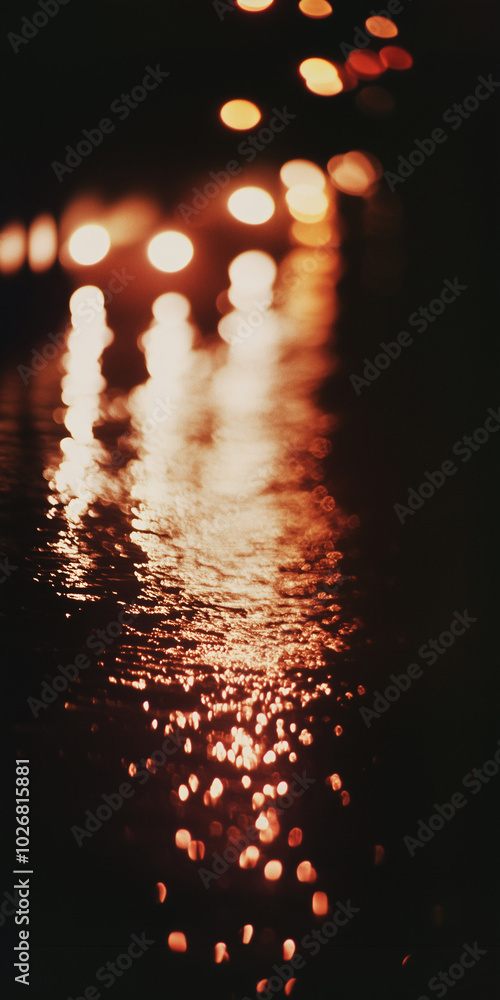 Car headlights reflecting in water during rain at night, capturing ...
