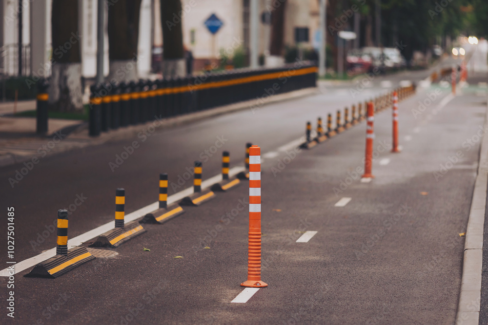 Straight two way cycle lane along side an asphalt road in the middle of ...