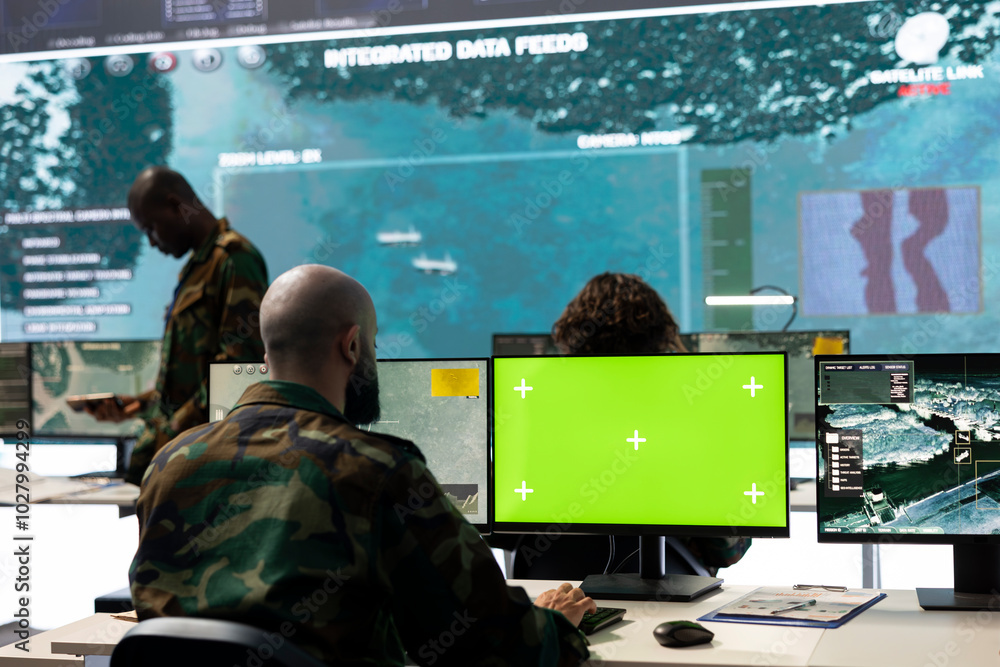 Recruit examining surveillance radar footage on monitor next to green ...