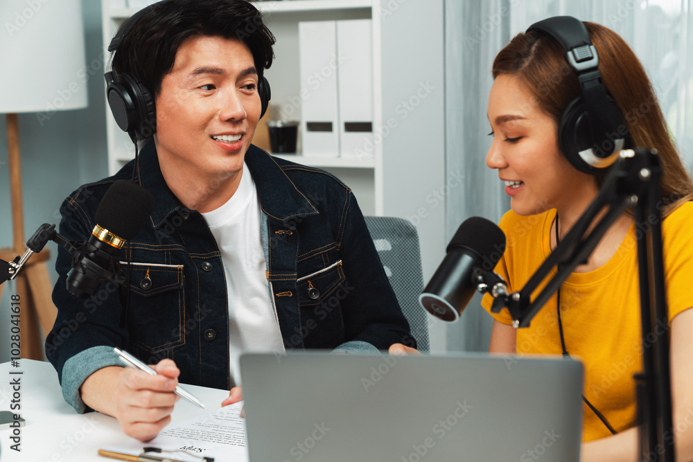 Smiling radio influencer hosts wearing headphones with channel social ...