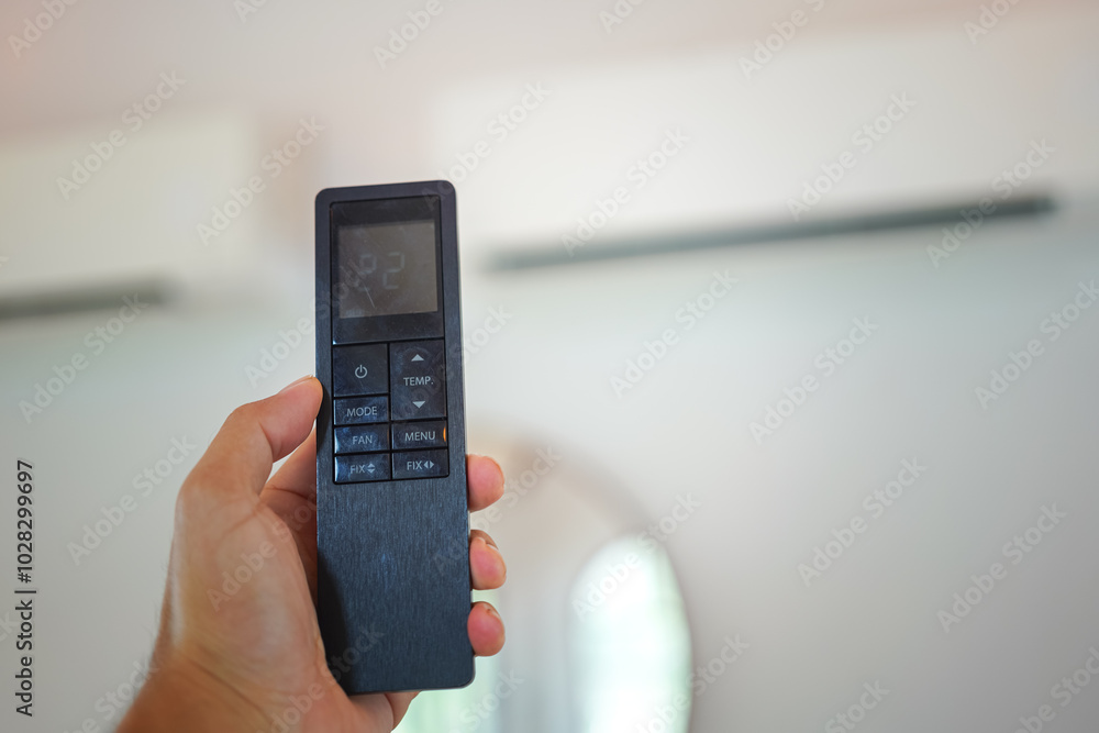 Human hand is turning-on air conditioner by pressing the button on ...