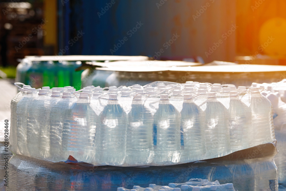 Bottled water in plastic containers packed for transportation ...