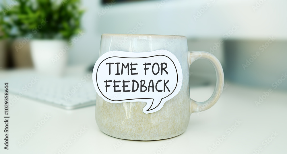 Time For Feedback text on sticker on cup with office desk background ...
