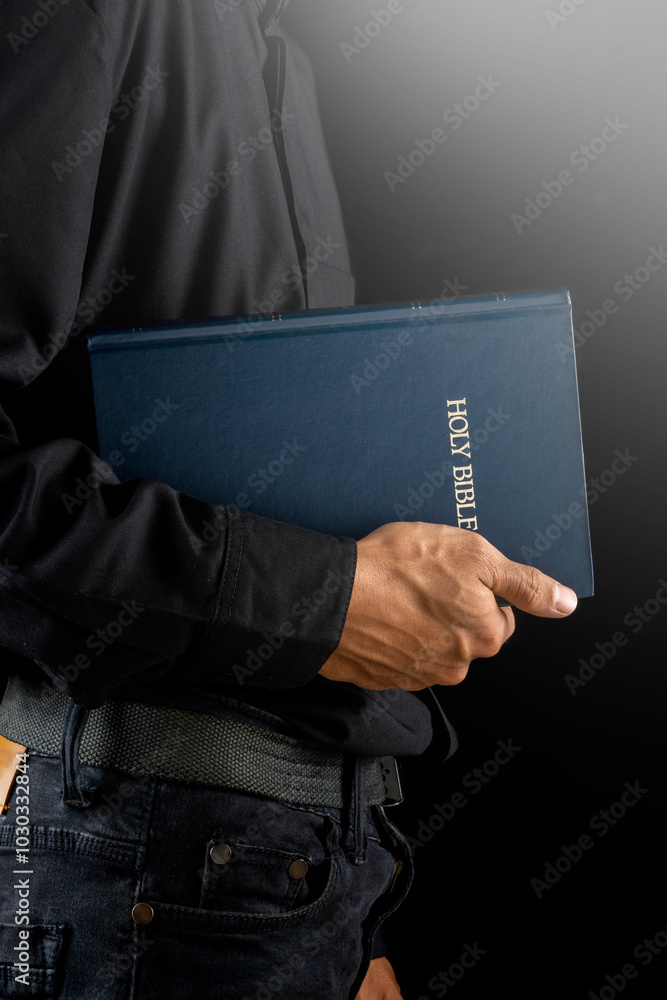 Man holding a holy bible in his hand. Symbol of faith and worship in ...