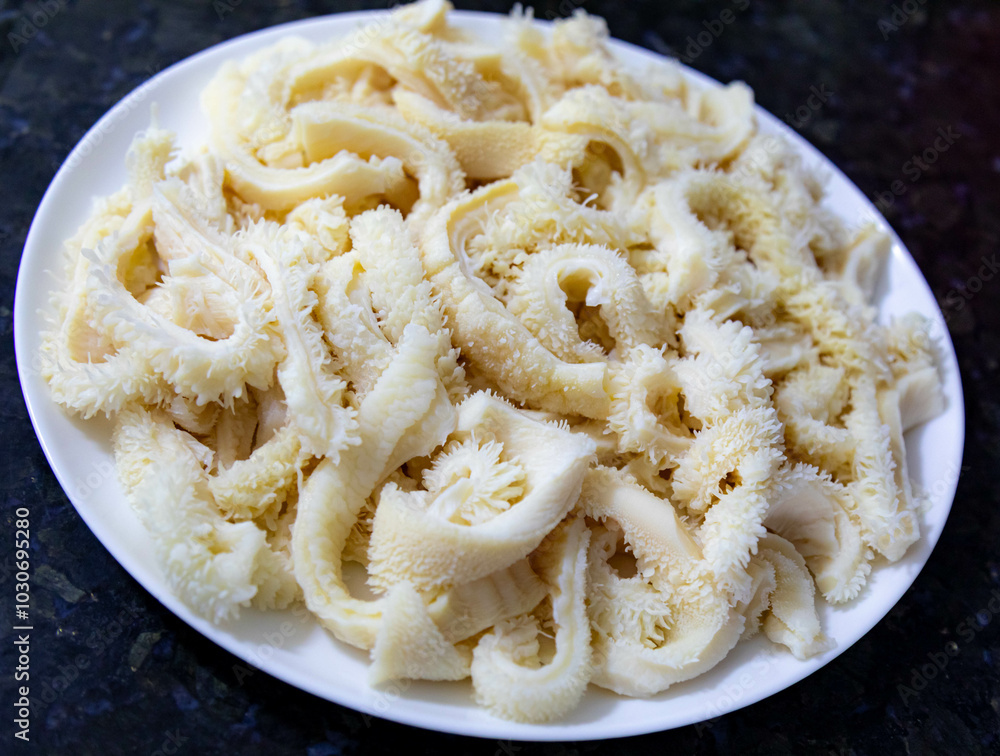 Beef tripe (bucho), beef stomach, tripe on a white plate. Dobradinha ...