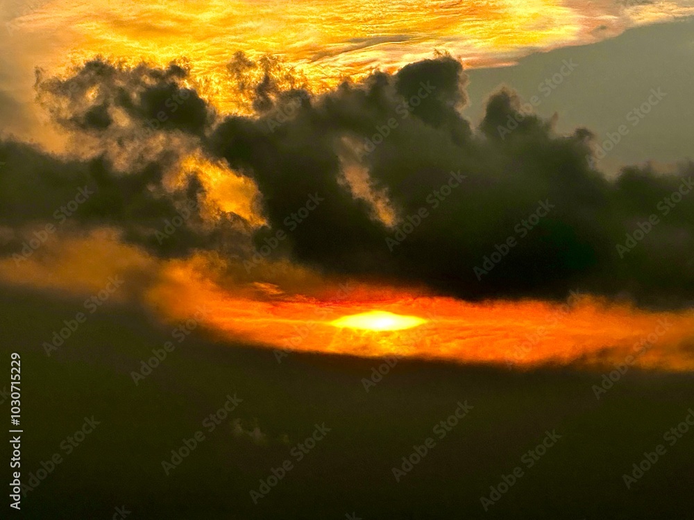 Sky with black clouds blocking the sun. Black clouds on orange sun ...