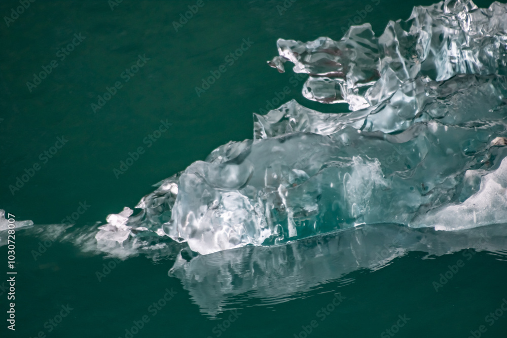 Solid chunk of Glacier Ice adrift in the ocean. Showcases a beautiful ...